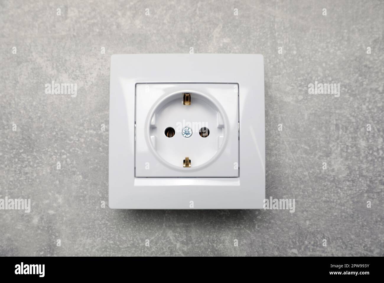 Modern plastic power socket on grey table, top view Stock Photo - Alamy