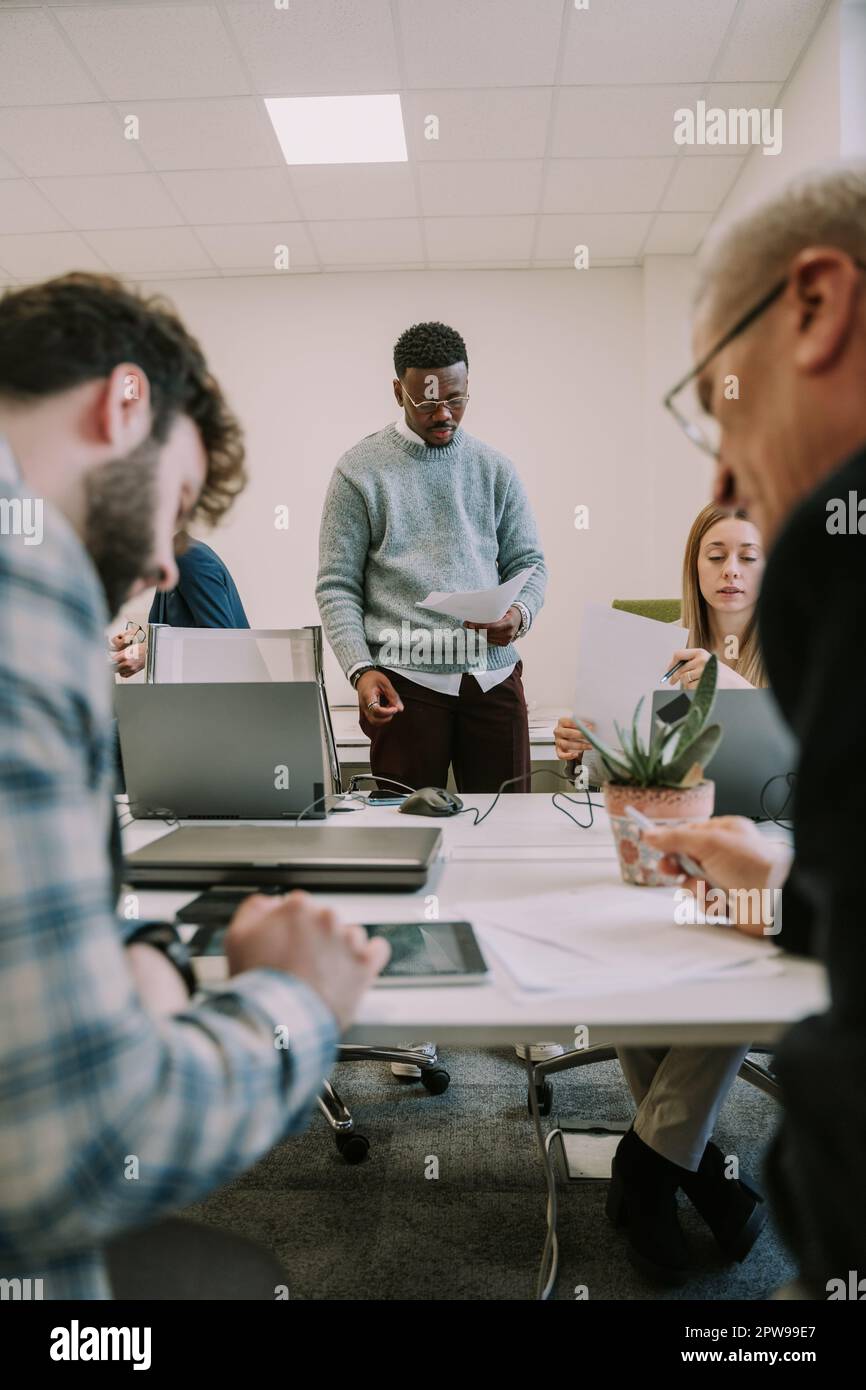 Work employee taking a break from work and reading the documents at the ...