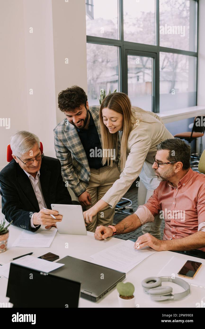 Four happy coworkers working in a great atmosphere in the office Stock ...
