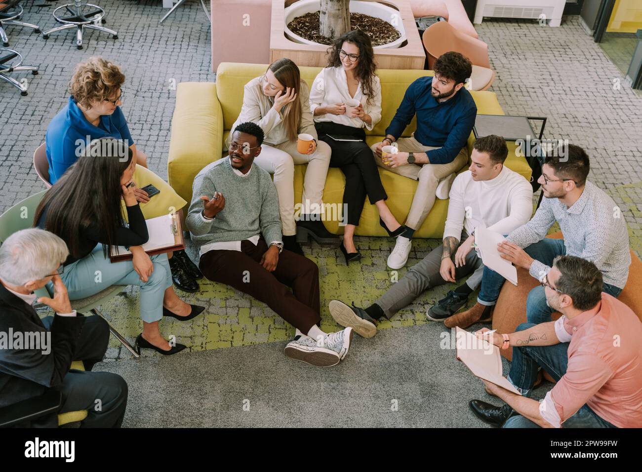 A group of coworkers listening to their colleagues having fun ...