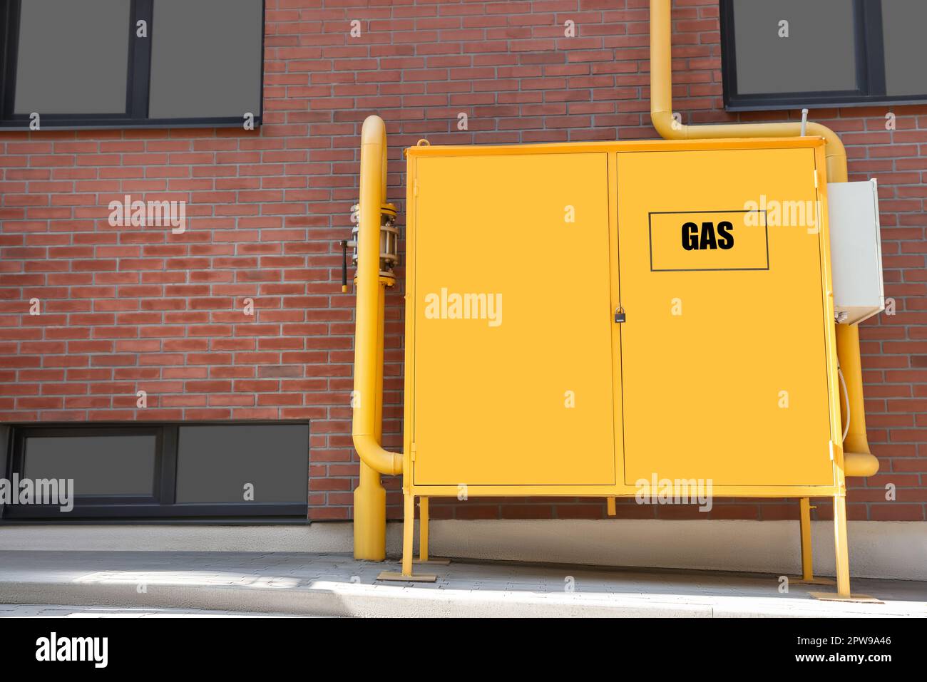 Gas distribution system with pipes near red brick wall outdoors Stock ...