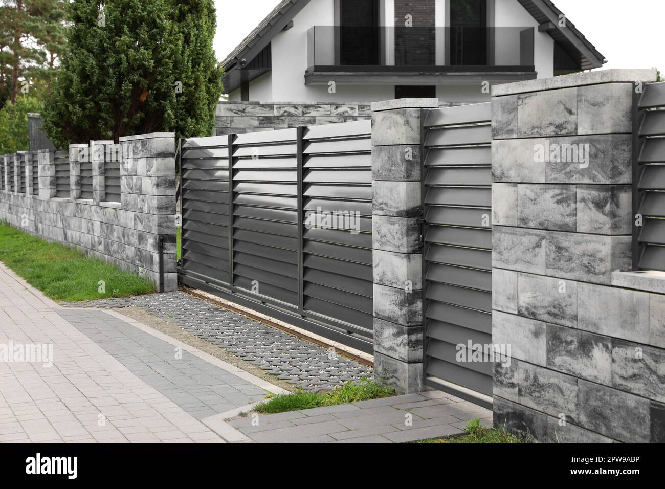 Metal gates near marble columns and house outdoors Stock Photo - Alamy