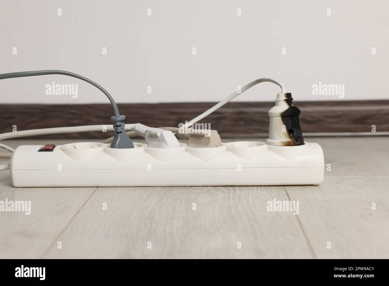 Burnt plug in power strip indoors. Electrical short circuit Stock Photo ...