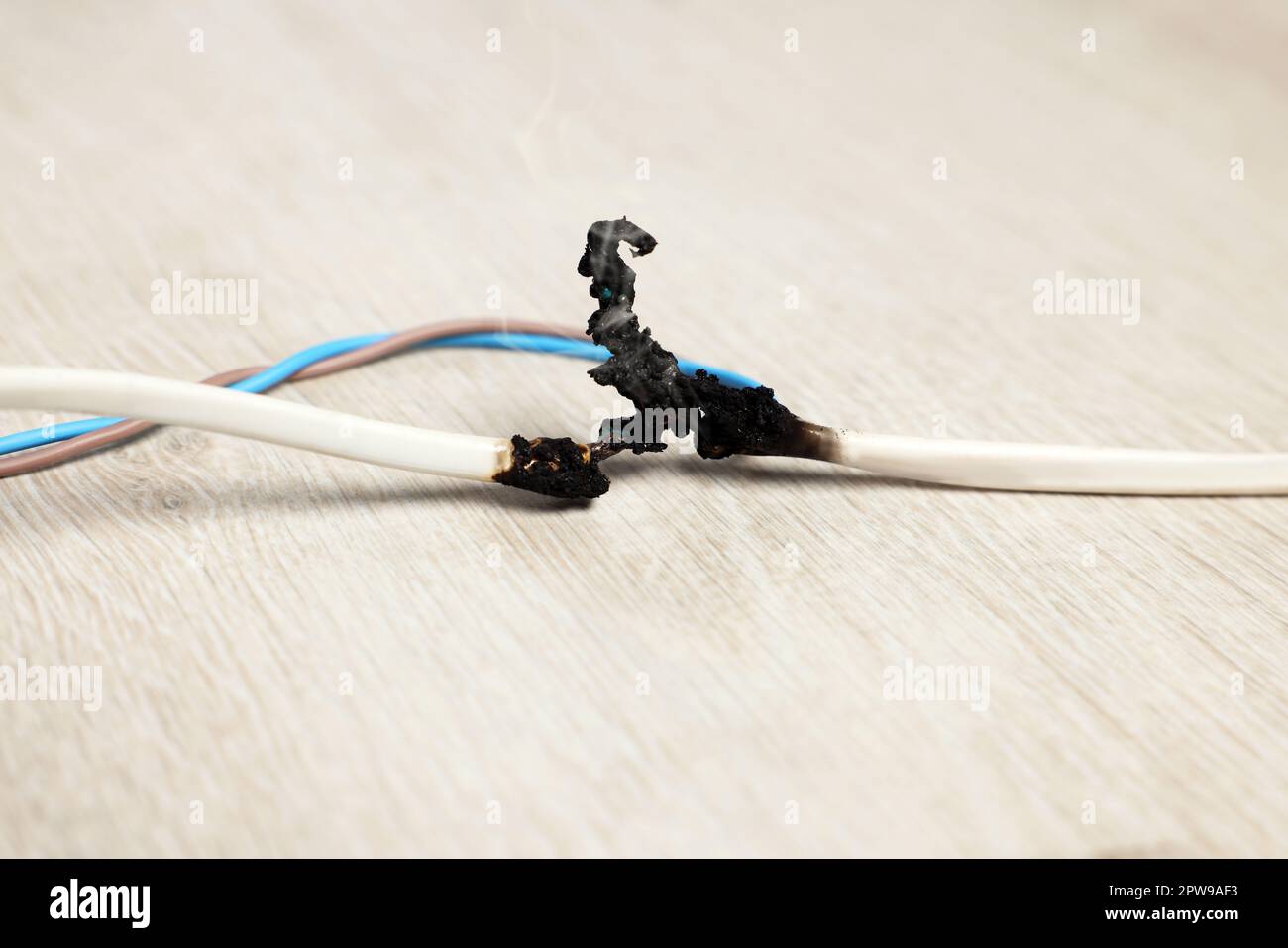 Burnt wires on wooden floor, closeup. Electrical short circuit Stock ...