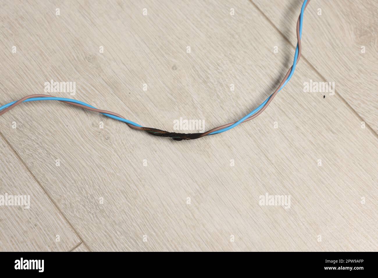 Burnt wires on wooden floor, above view. Electrical short circuit Stock ...