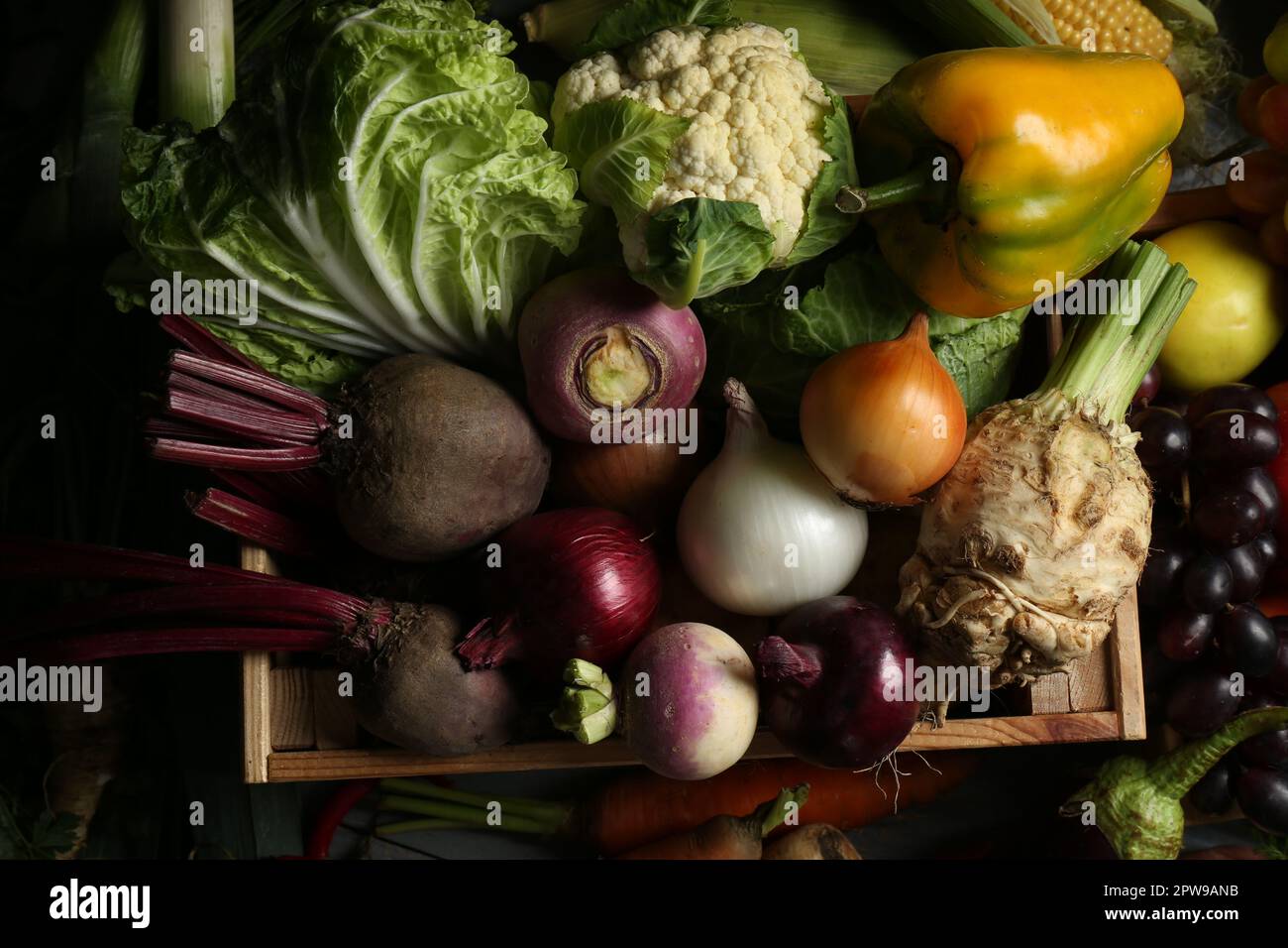 Different fresh vegetables with wooden crate as background, flat lay ...