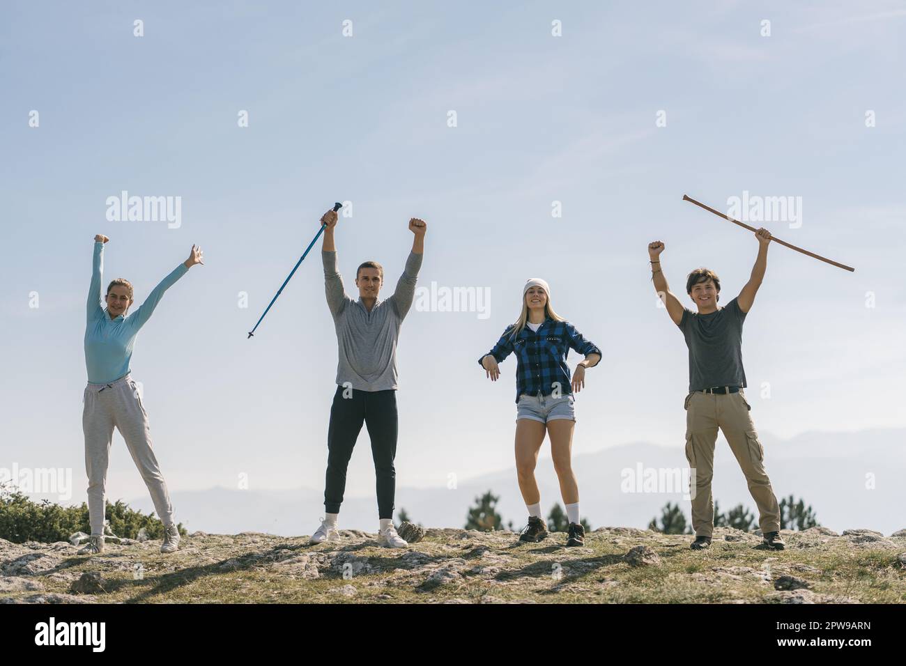 Hiking friends successfully climbed up on top of the mountain. They are ...