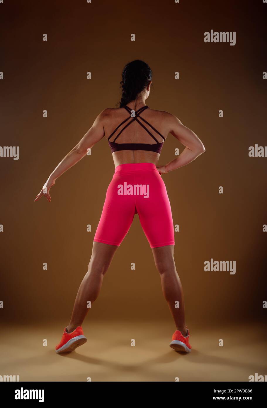 A back view photo of fit female exercising her calf muscles Stock Photo ...