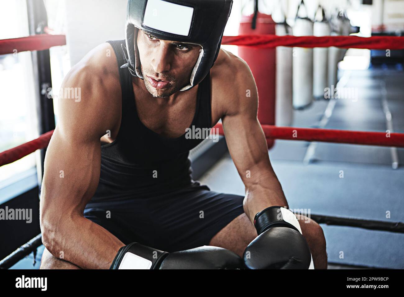 Winning is all a matter of mindset. a young man training in a boxing ...