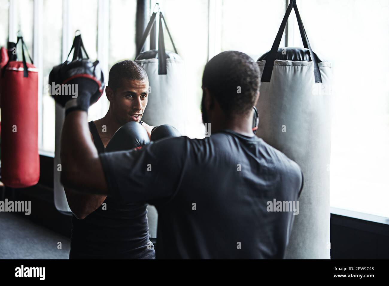 Train hard, fight easy. a male boxer practising his moves with his ...