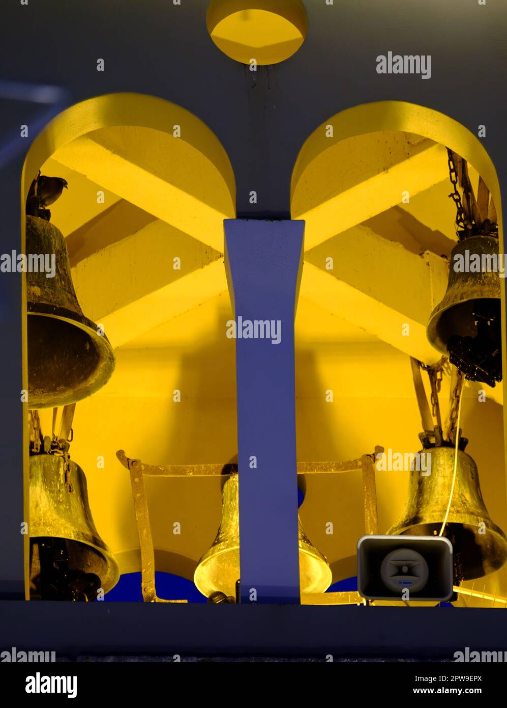 Greek orthodox church bells illuminated at night in a church in Preveza ...