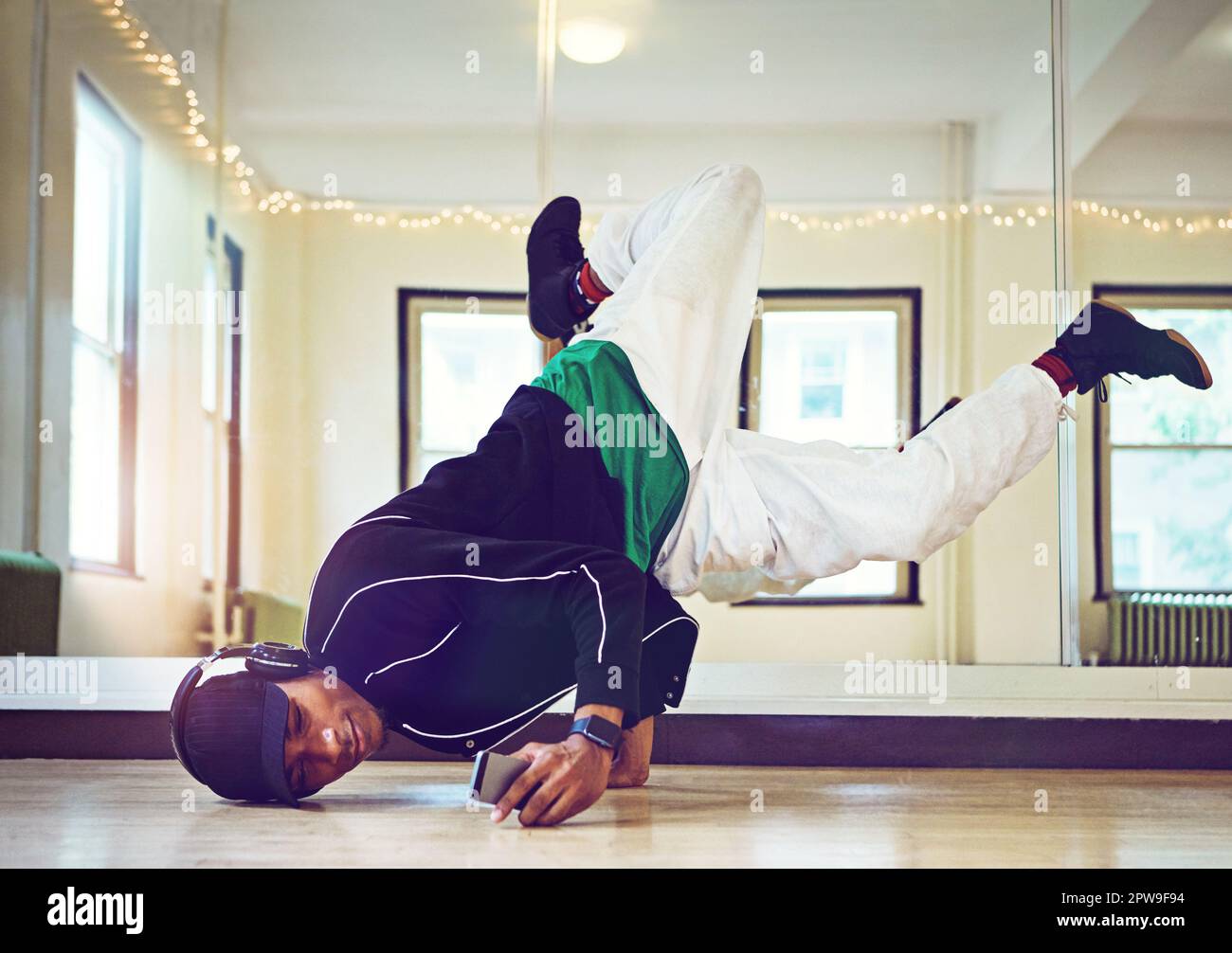 Bring the beat and hell bring the moves. a young man using his phone ...