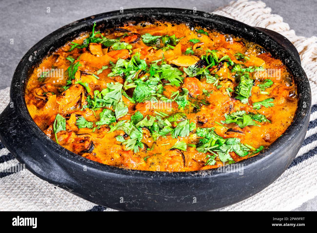 Charru Mussel, known in Brazil as a sururu moqueca, on white striped ...