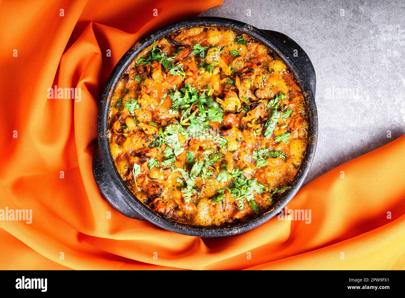 Charru Mussel, known in Brazil as a sururu moqueca, on white wooden ...
