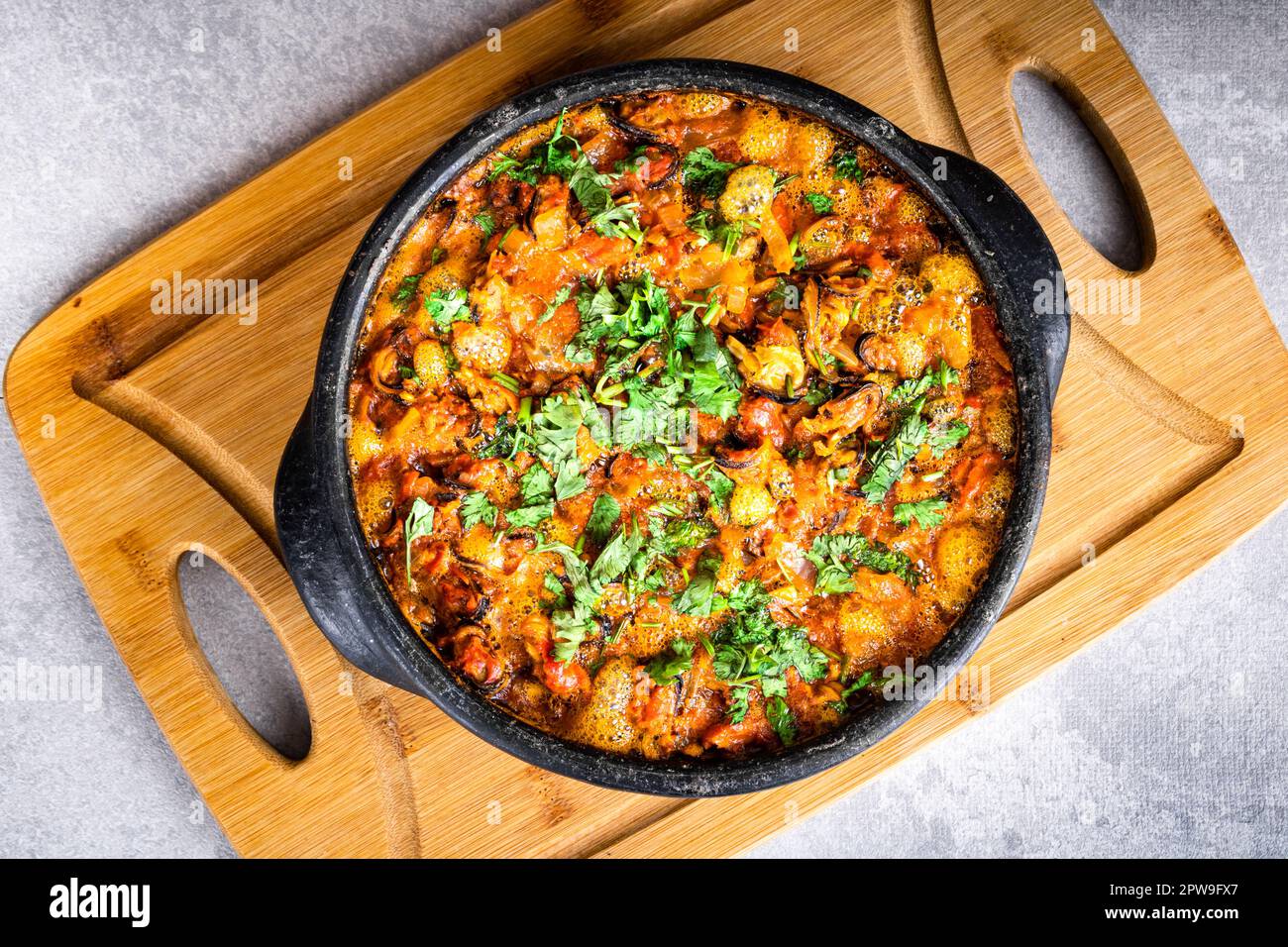 Charru Mussel, known in Brazil as Sururu Moqueca, on wooden board. Top ...