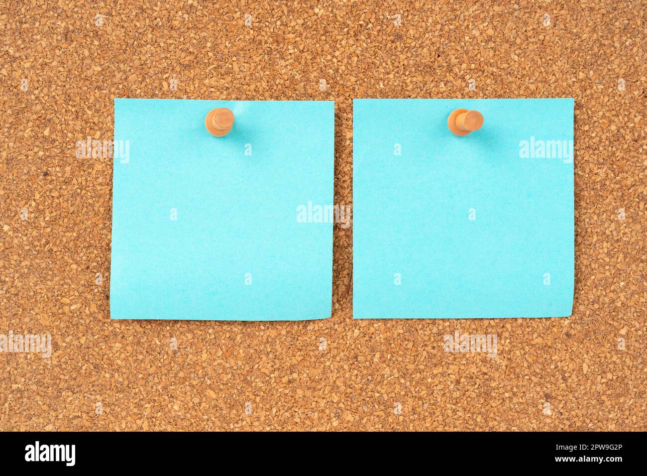 Blank blue color sticky note paper and wooden thumbtack on wooden ...