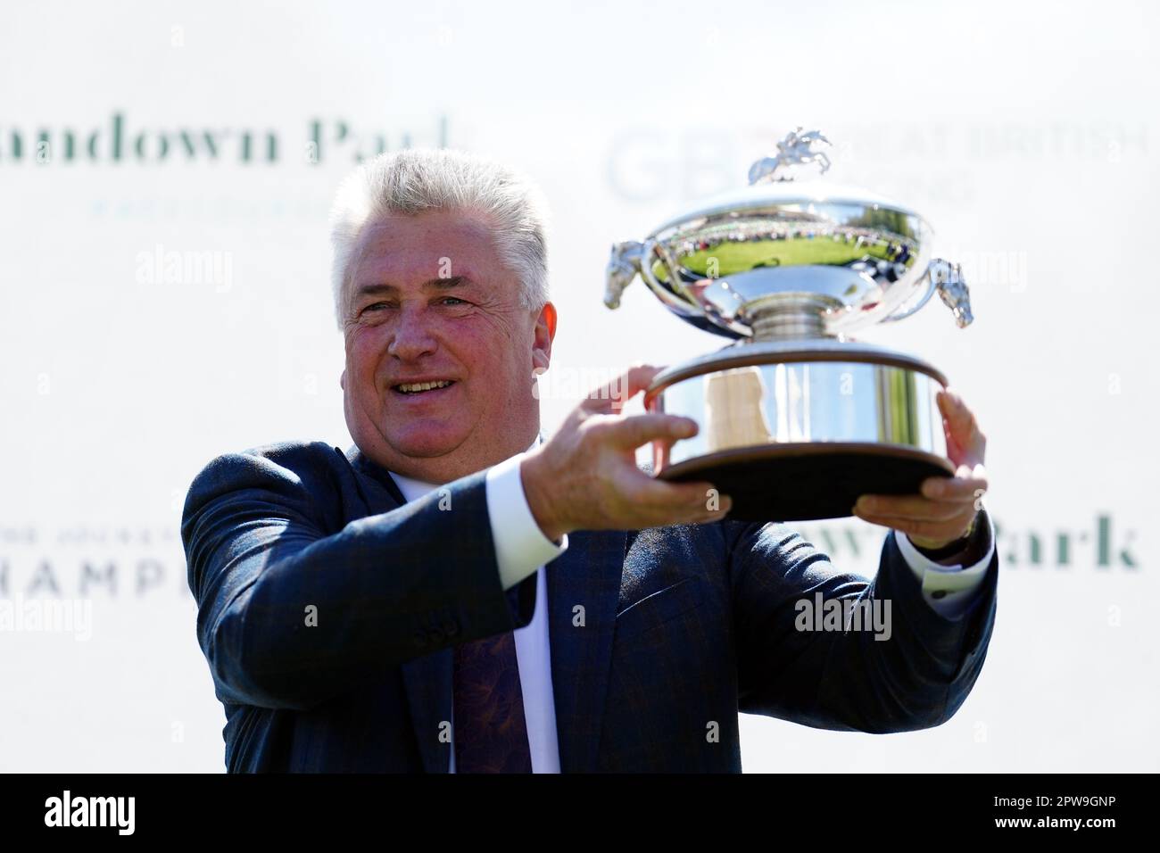 Paul Nicholls receives the champion trainer trophy at Sandown Park ...