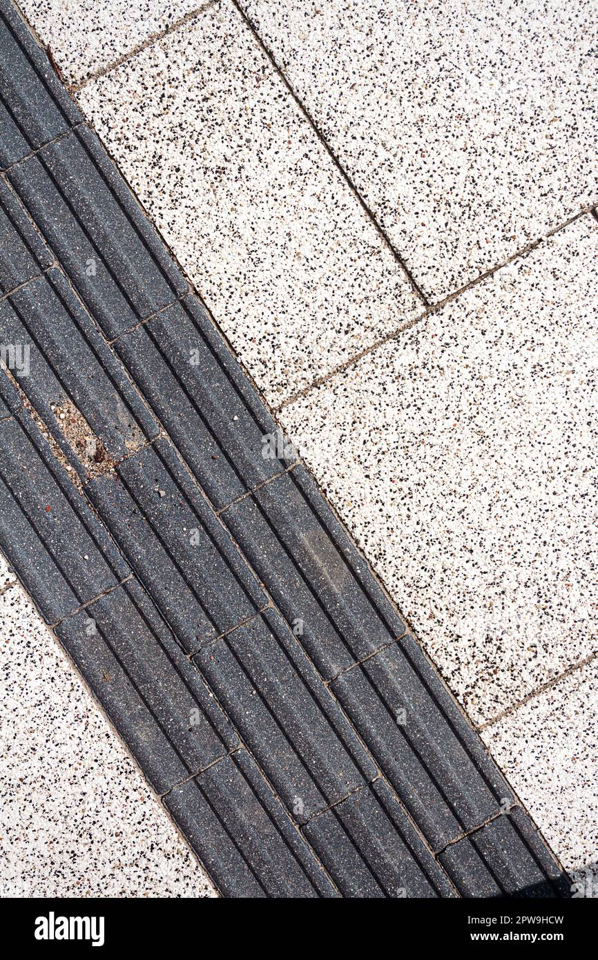 Textured walkway for blind people. Black tactile paving for the ...