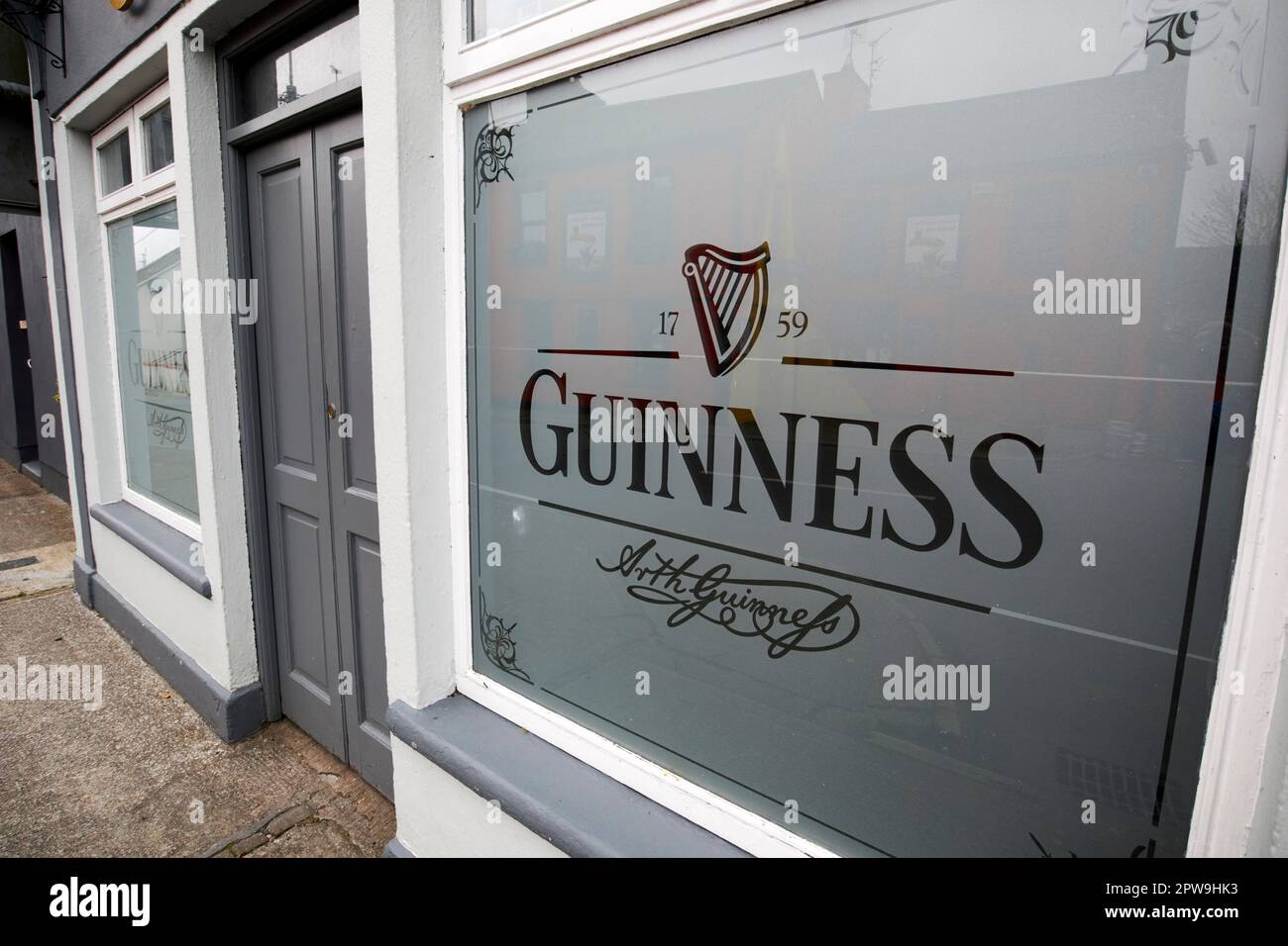 guinness etched window of a small pub in main street corofin county ...