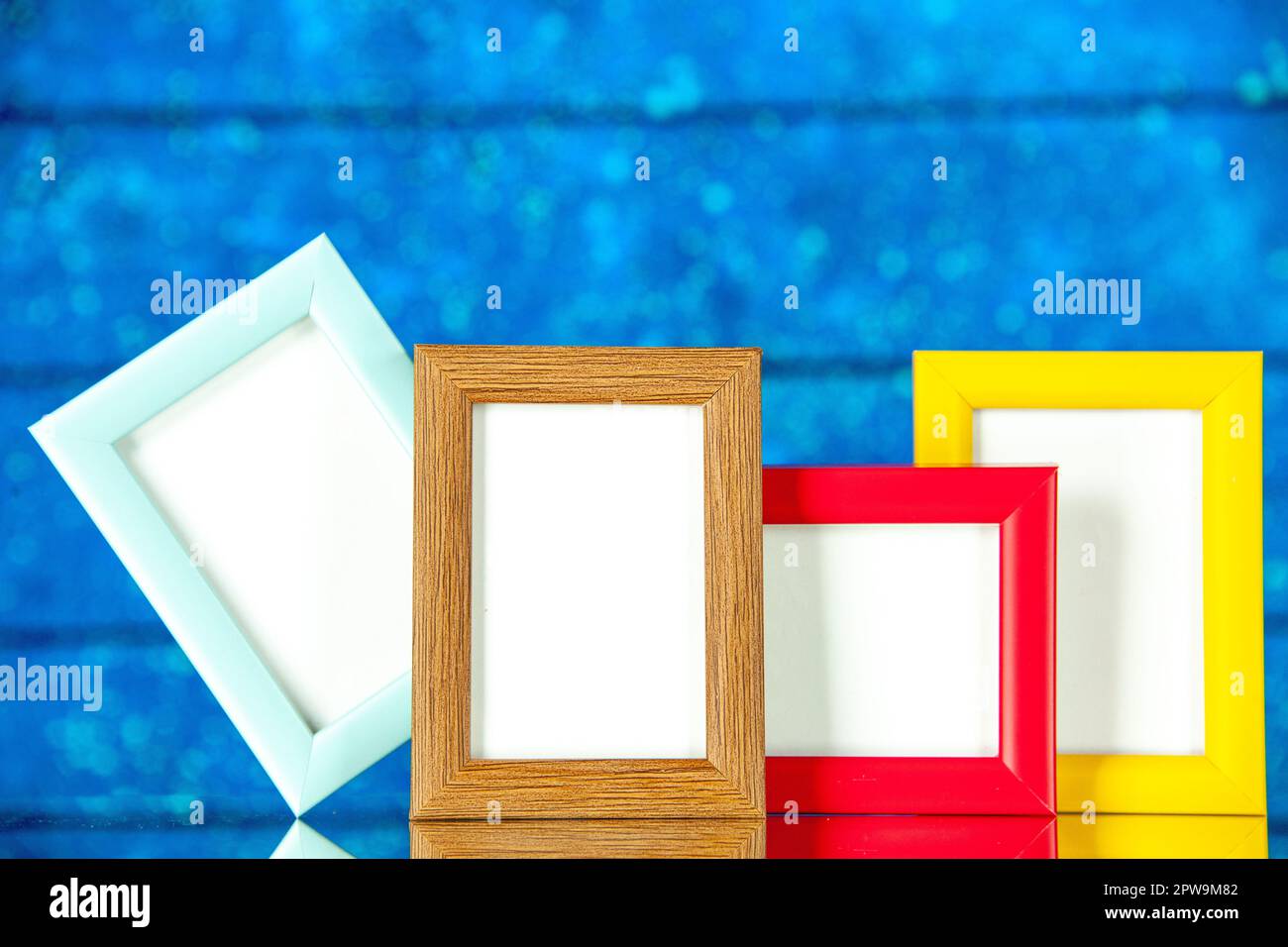 front view beautiful picture frames with colored corners on blue ...