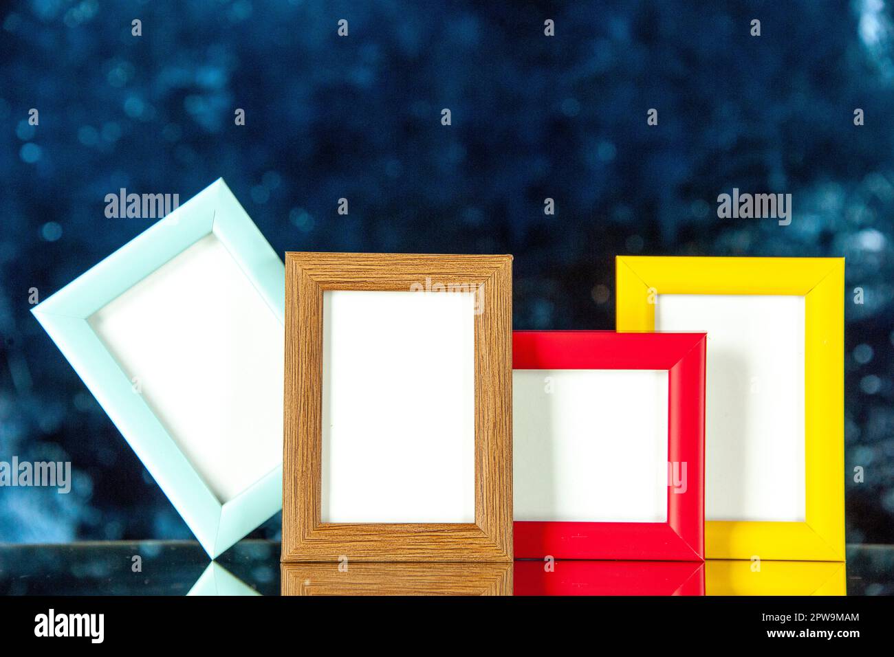 front view different picture frames with colored corners on a dark ...