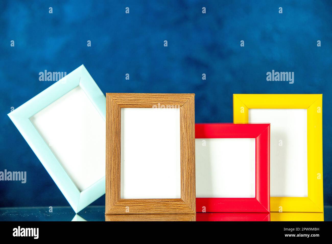 front view different picture frames with colored corners on a dark-blue ...