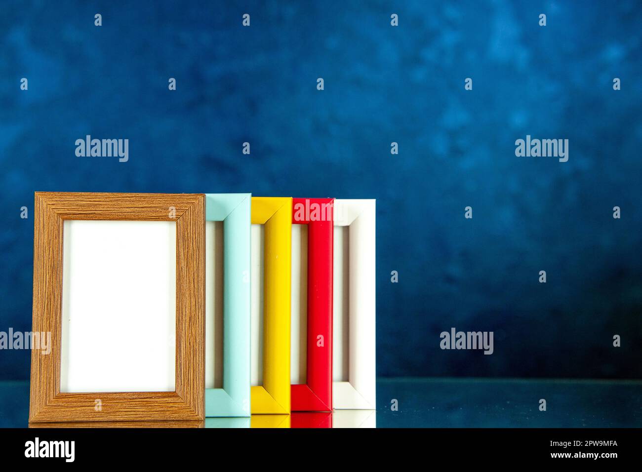 front view different picture frames with colored corners on blue ...