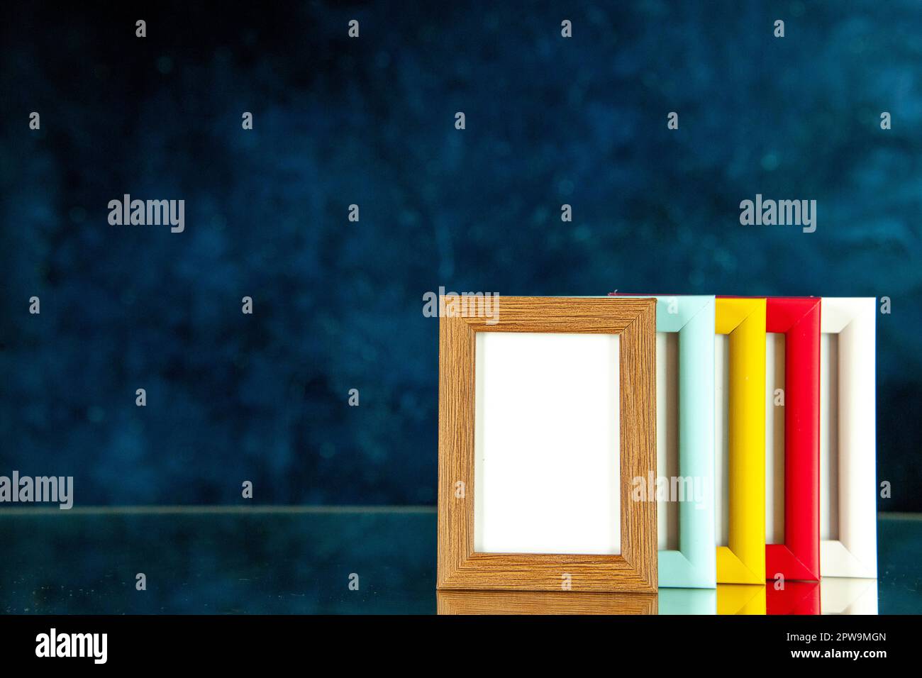front view different picture frames with colored corners on dark-blue ...