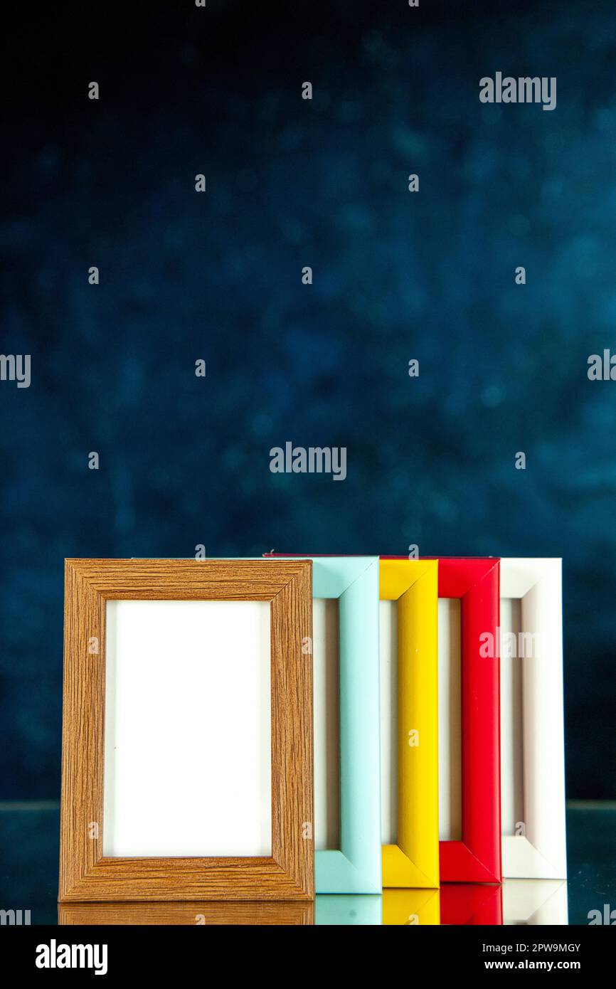 front view different picture frames with colored corners on dark-blue ...