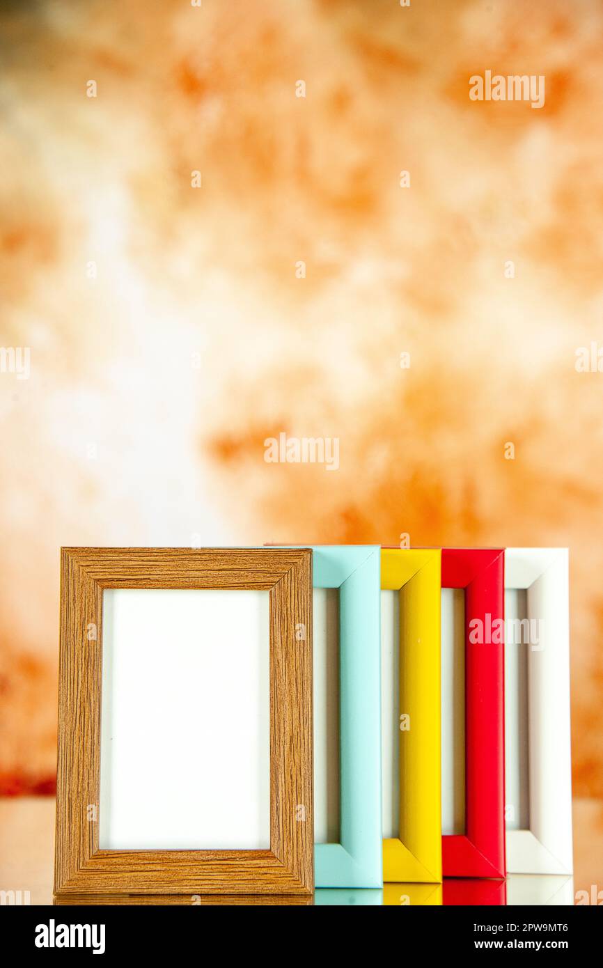 front view different picture frames with colored corners on light brown ...