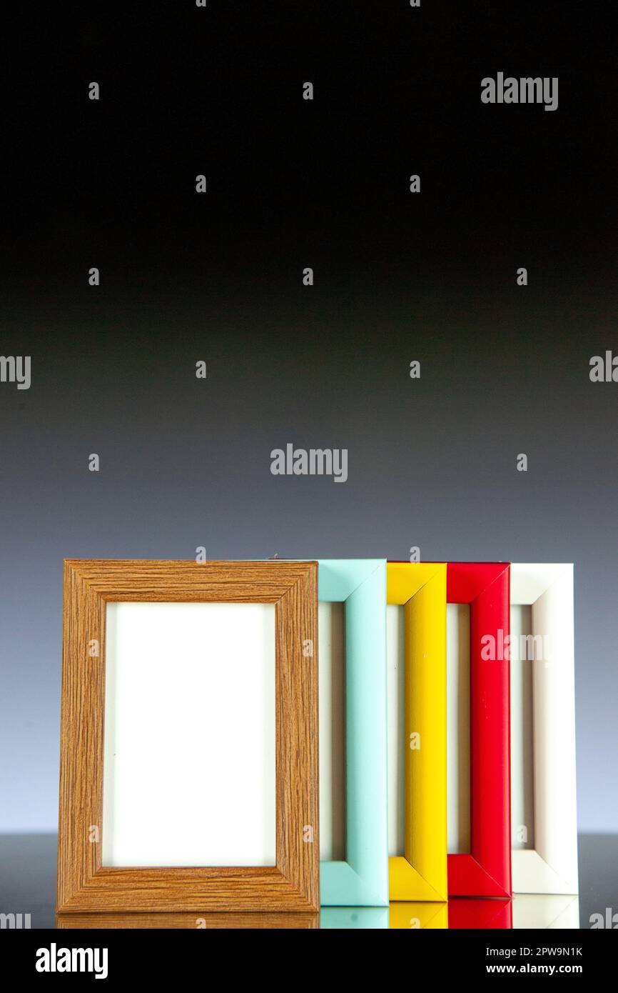 front view different picture frames with colored corners on light dark ...