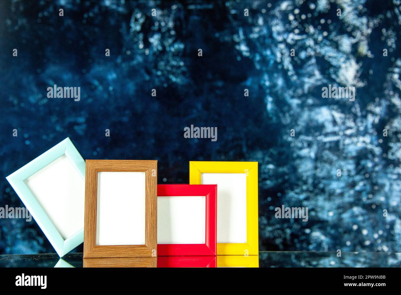 front view different picture frames with colored corners on the dark ...