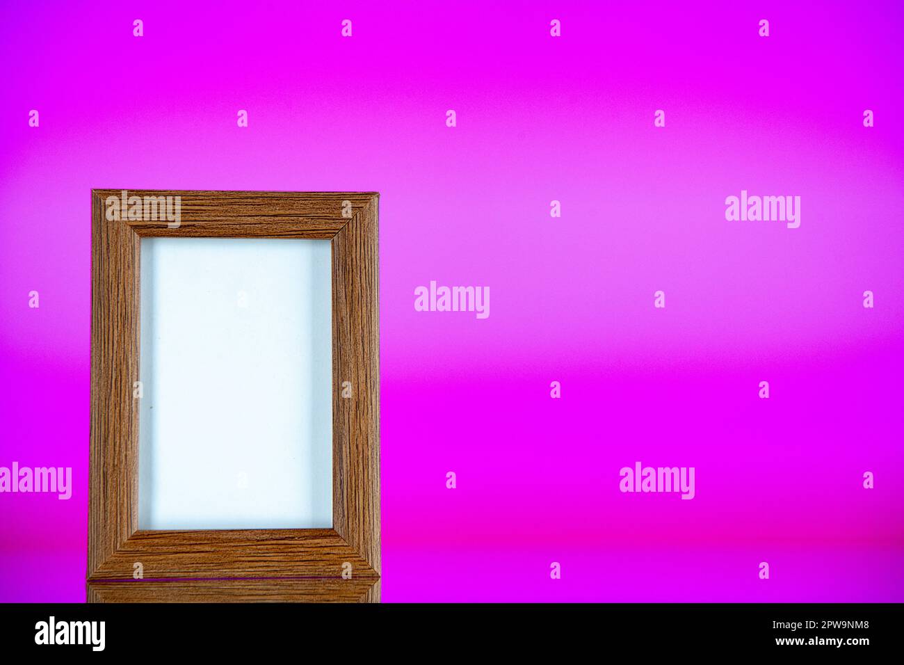 front view elegant picture frame on light pink background color present ...