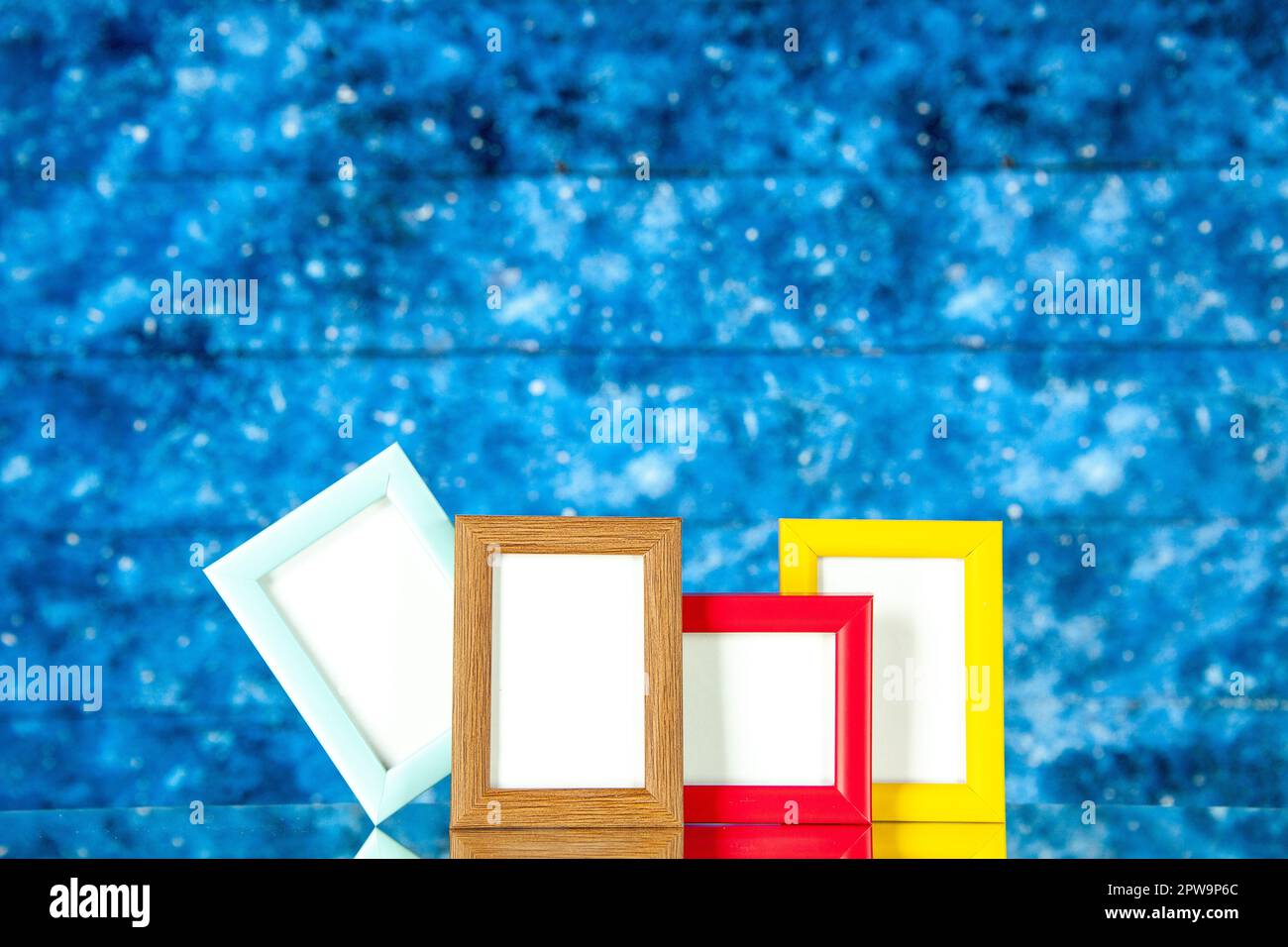 front view picture frames with colored corners on blue background ...