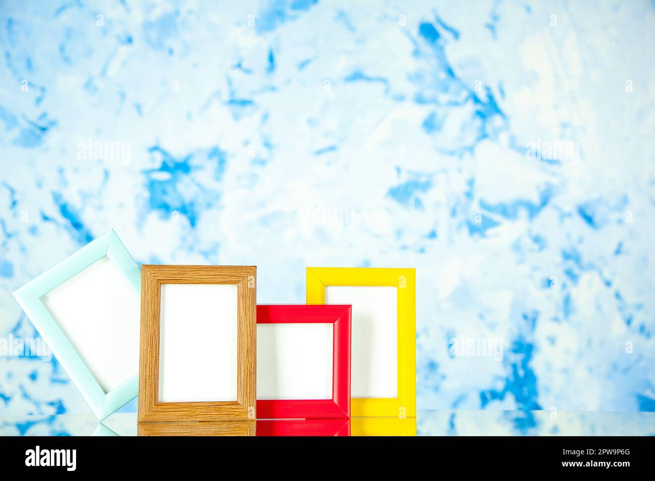 front view picture frames with colored corners on a light-blue ...