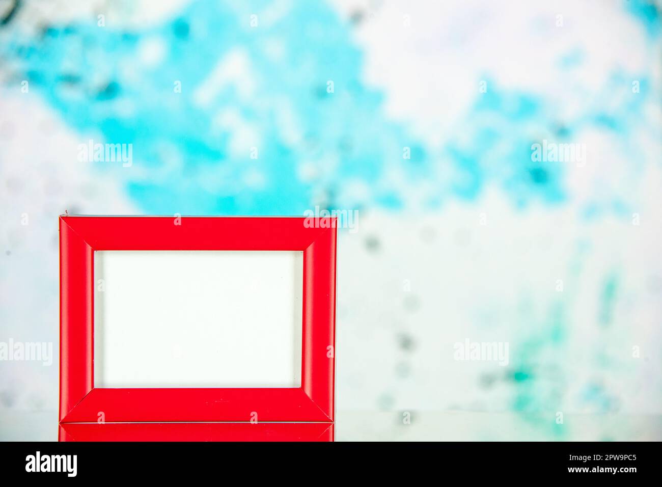 front view red picture frame on light blue background shoot family ...