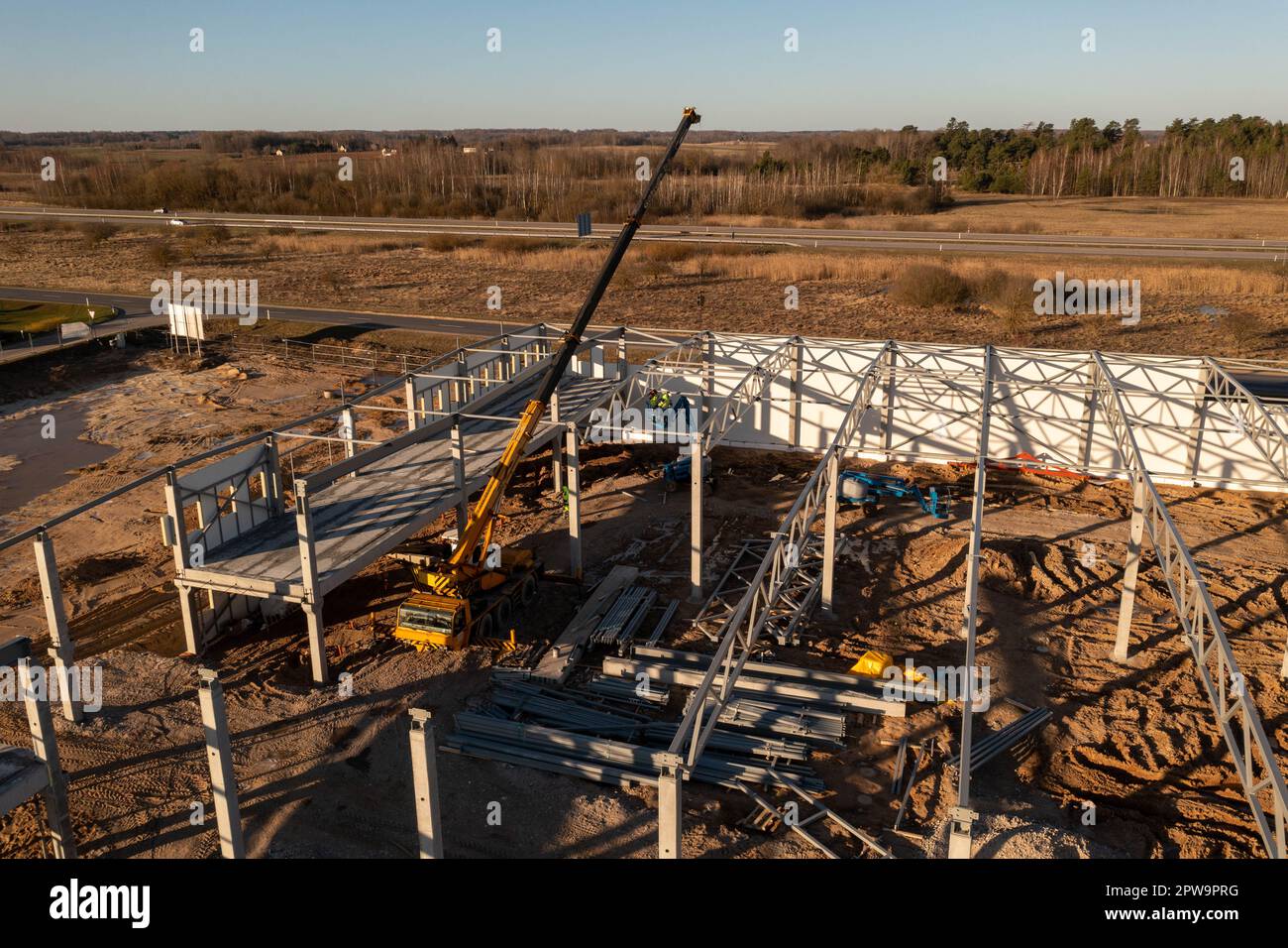 Drone photography of warehouse being built by construction workers ...
