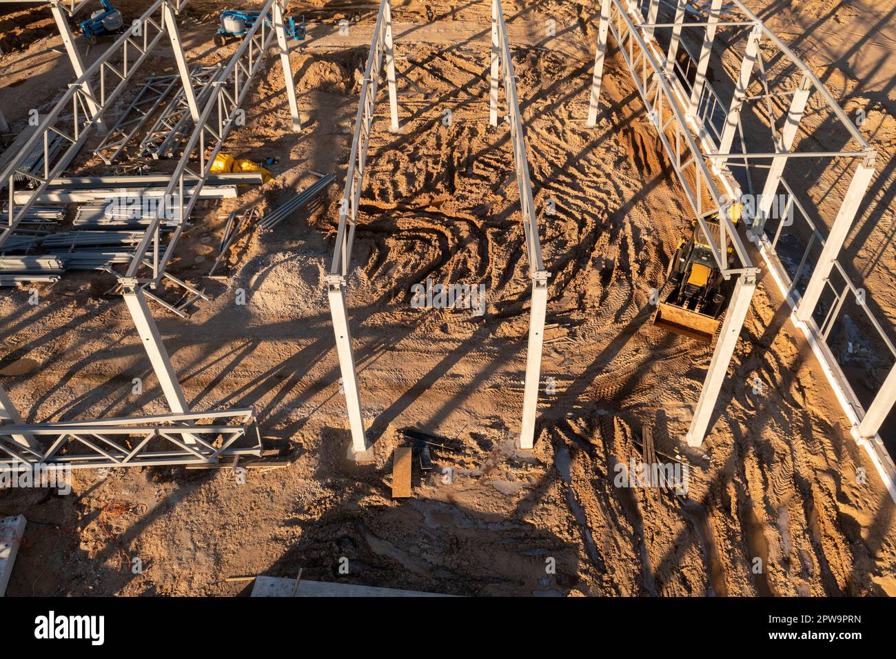Drone photography of warehouse being built by construction workers ...