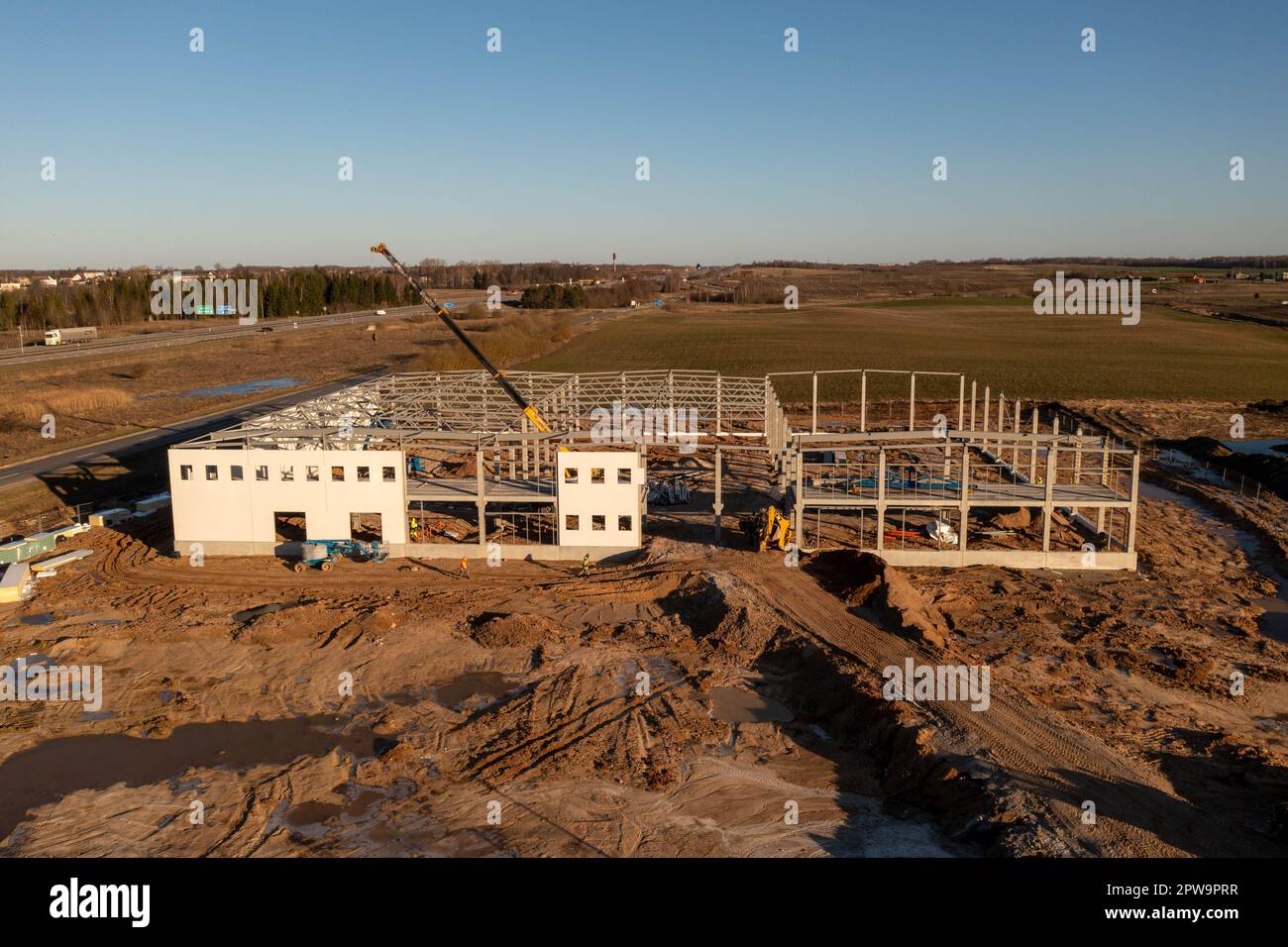 Drone photography of warehouse being built by construction workers ...