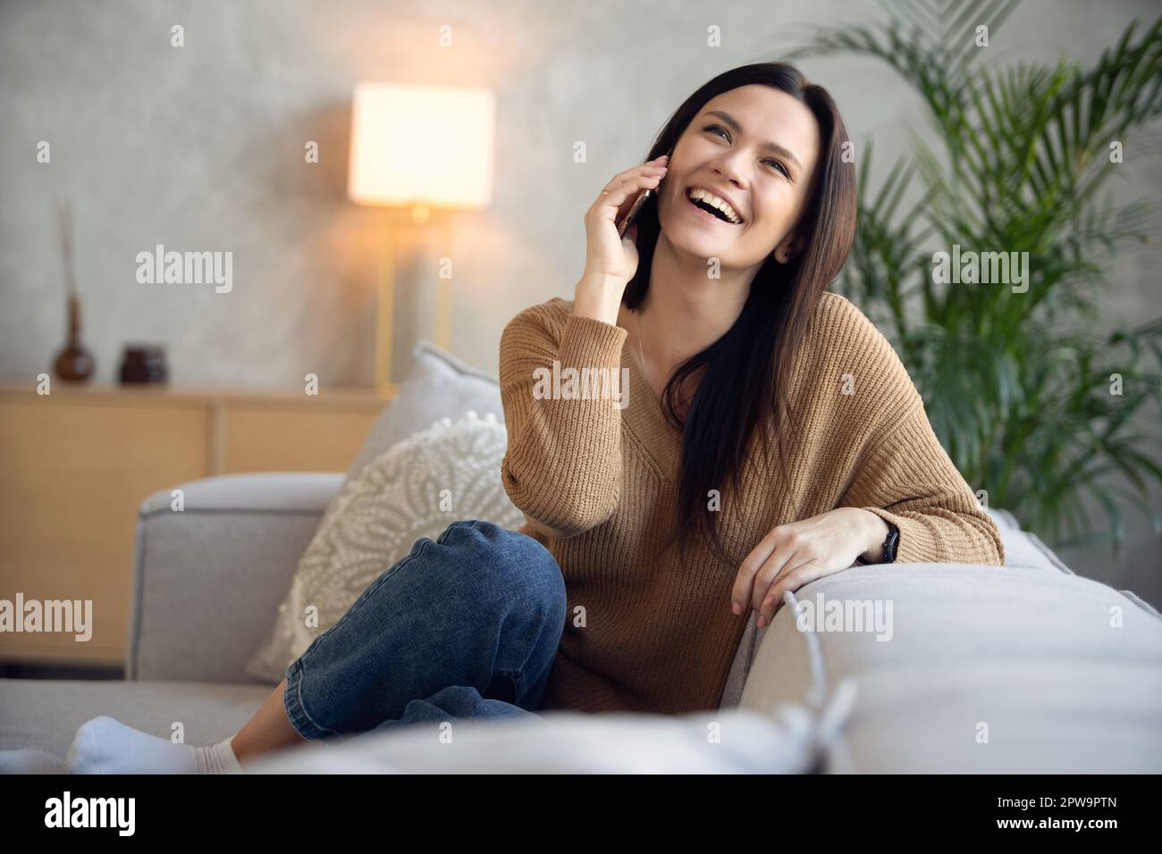 Happy 30s woman caller talking on the phone at home, cheerful lady ...