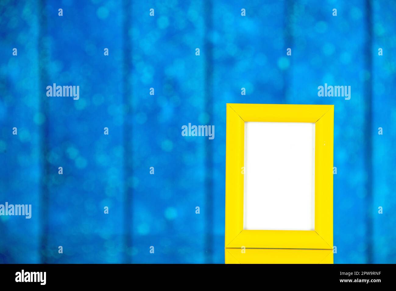 front view yellow picture frame on blue background portrait photo color ...