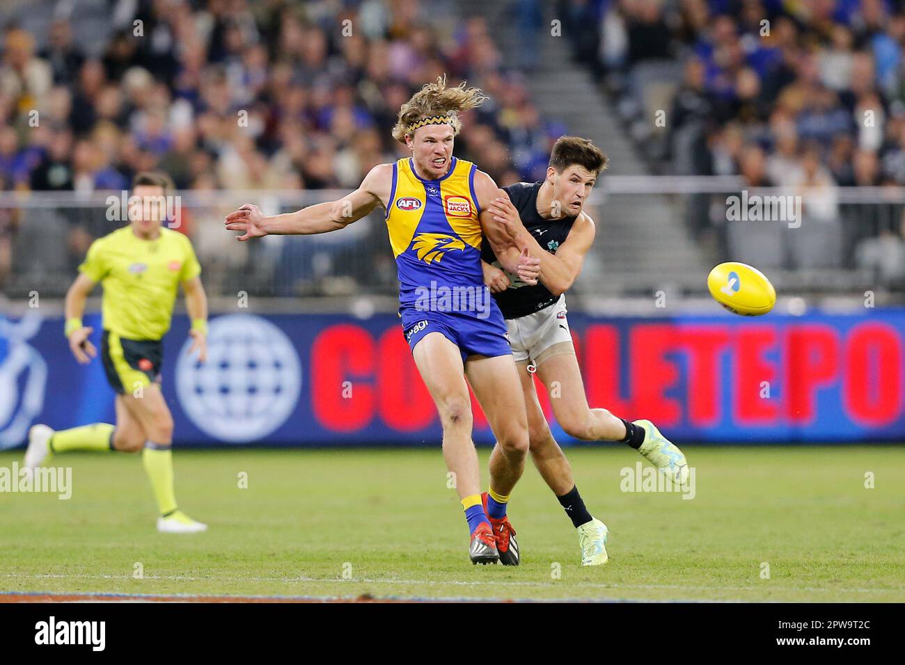 Jayden Hunt of the West Coast Eagles gets his kick away under pressure ...