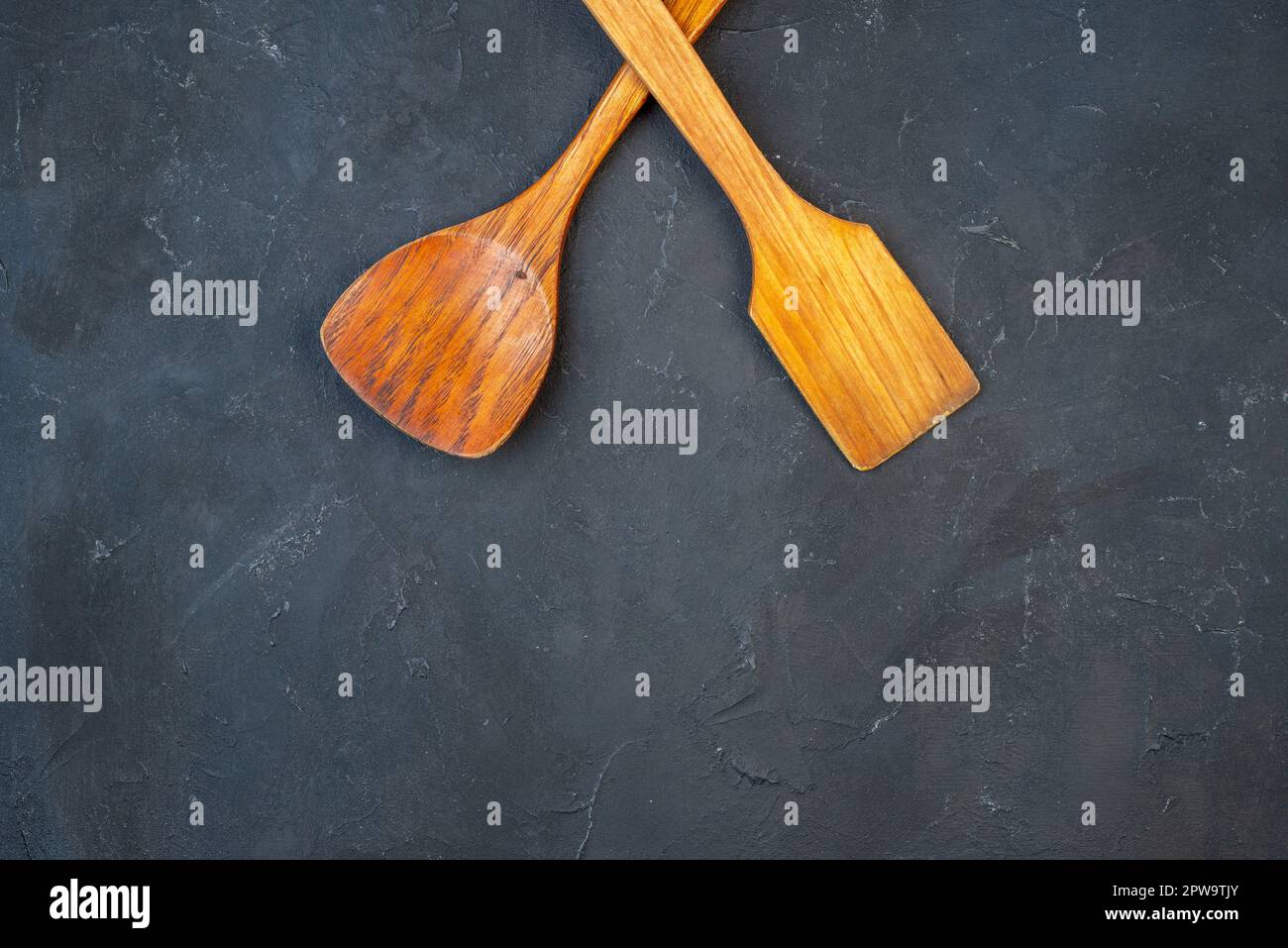 top view wooden spoons on dark background free place Stock Photo - Alamy