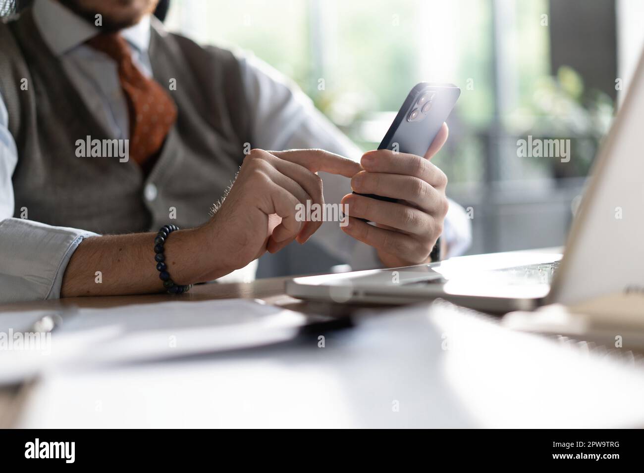 Closeup view of male hands touching mobile phone. Middle-aged man using ...
