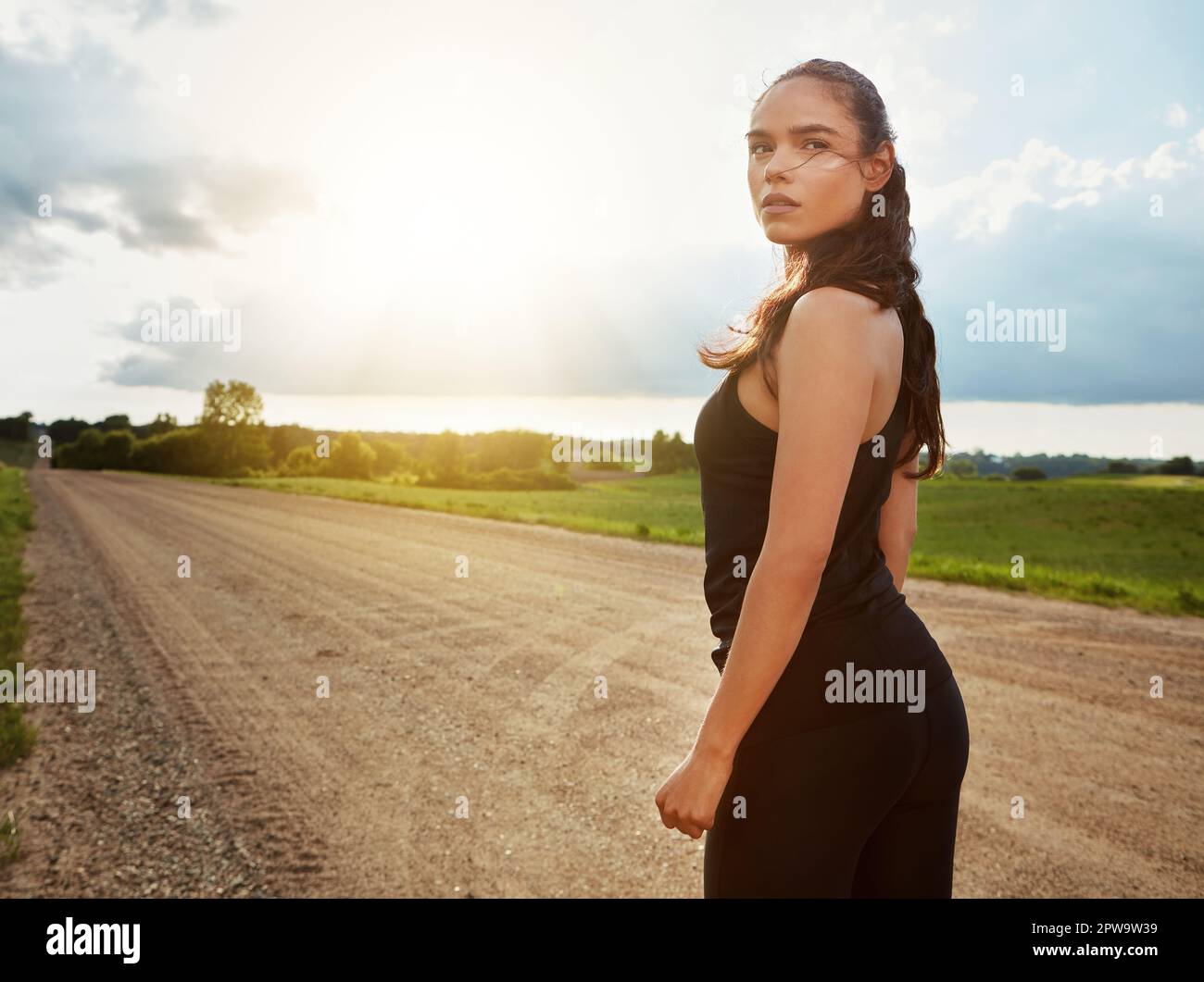 Dont wish for a good body, work for it. a fit young woman out for a run on a beautiful day Stock ...