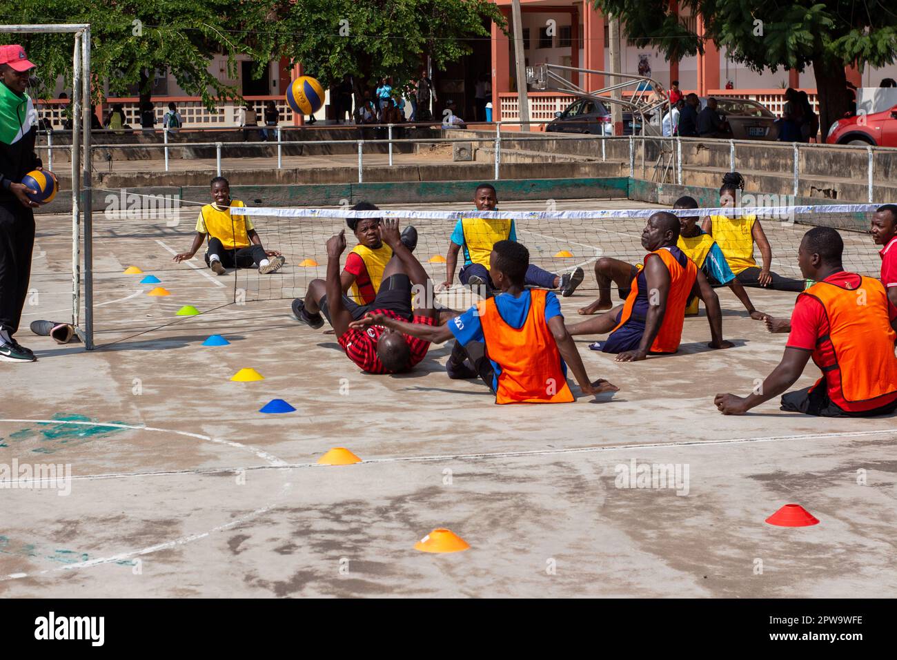 Amateur athletes playing sitting volleyball, a form of volleyball for ...