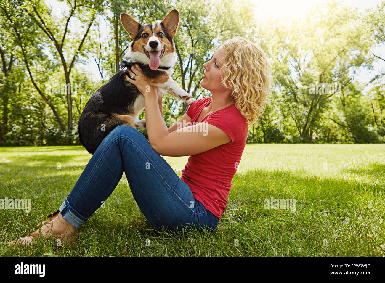 Letting her dog know just how much she loves him. a young woman bonding ...