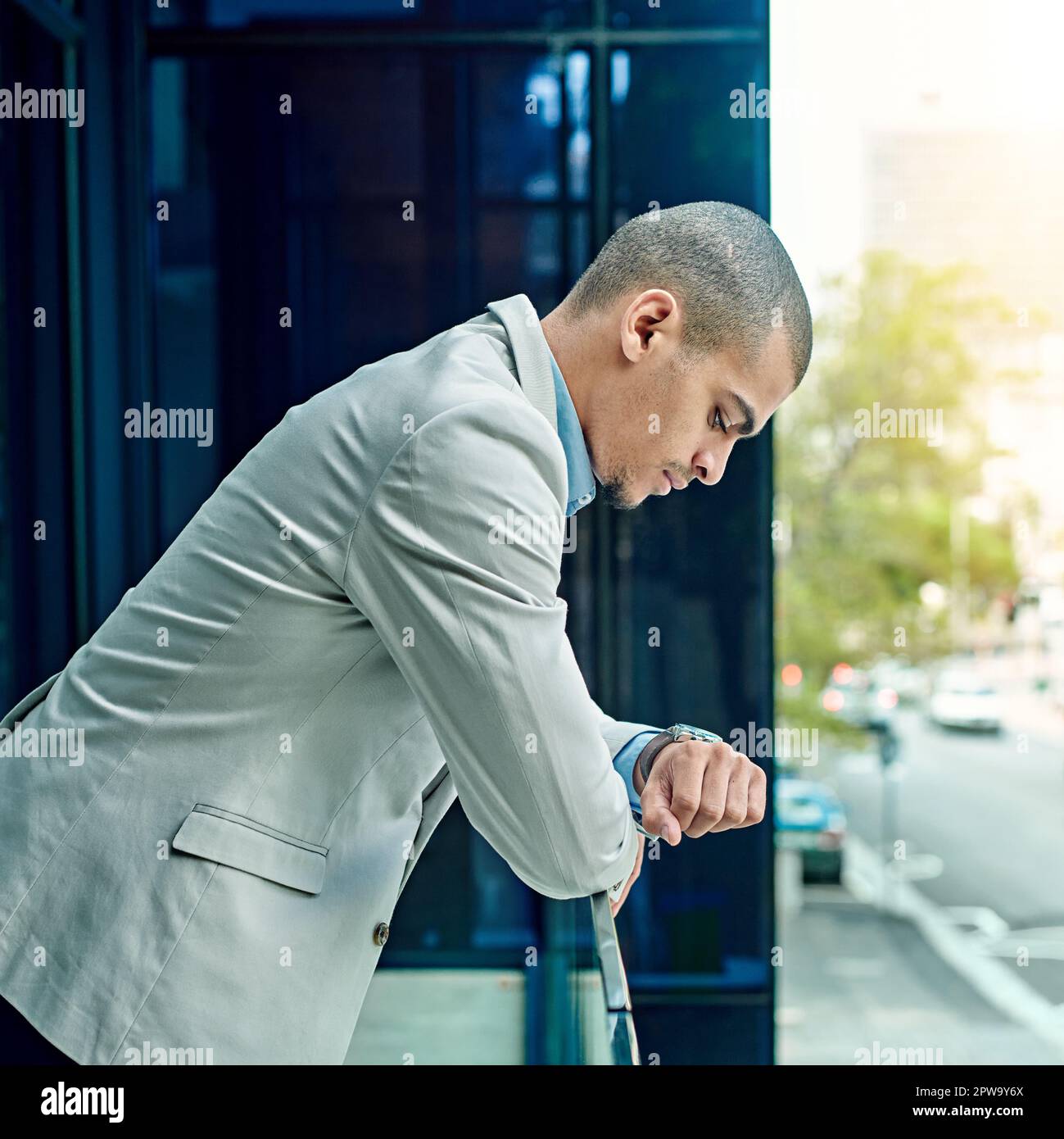 Theres no time like the present. a young businessman checking the time ...