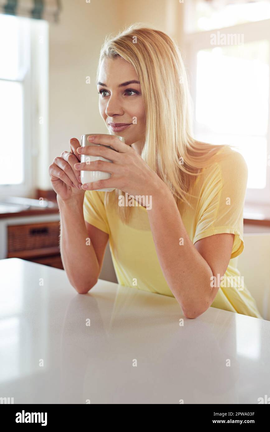 Cant start the day without coffee. a woman drinking coffee in her ...