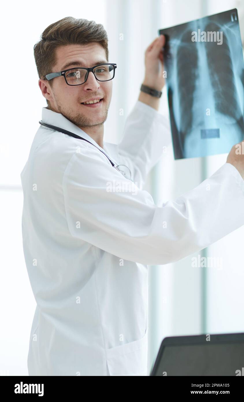 Male doctor radiologist examines x-rays in a medical office Stock Photo ...